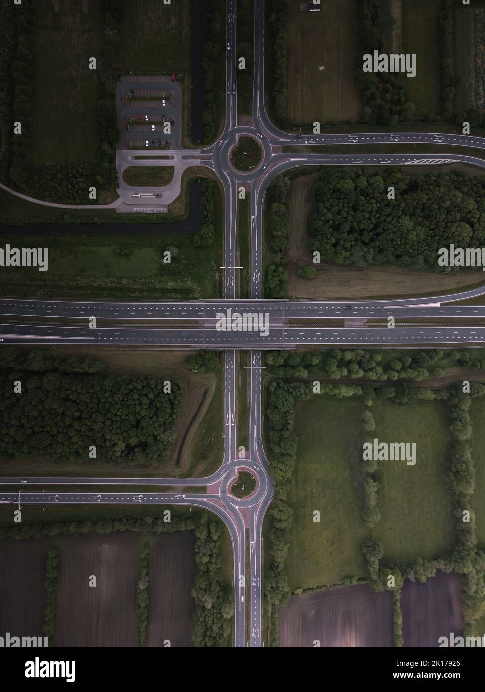 A drone shot of a highway showing the long stretch of road with cars ...