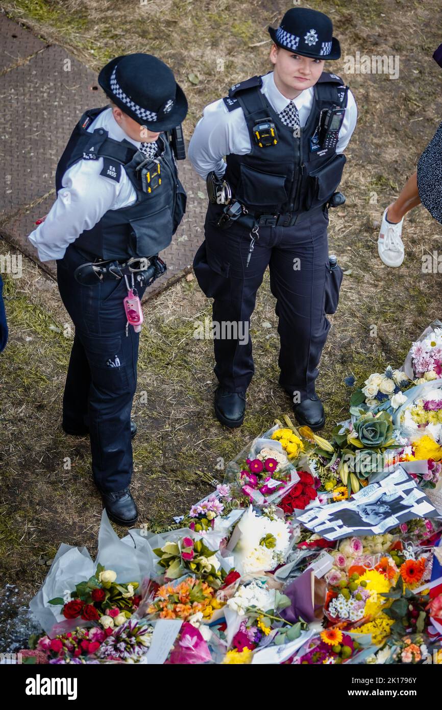 Police officers take time to read the tributes to Her Majesty Queen ...