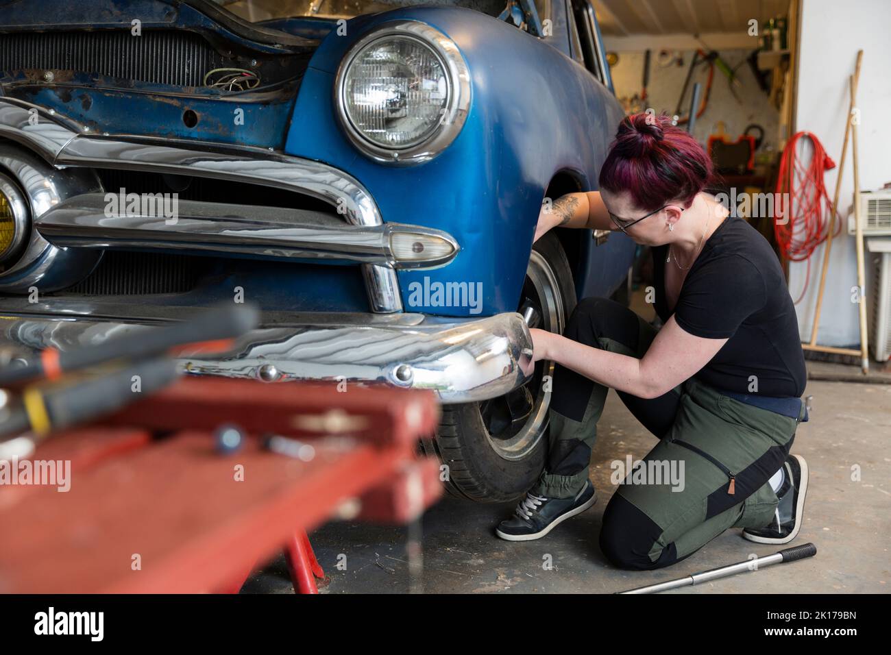 Woman repairing vintage car Stock Photo - Alamy