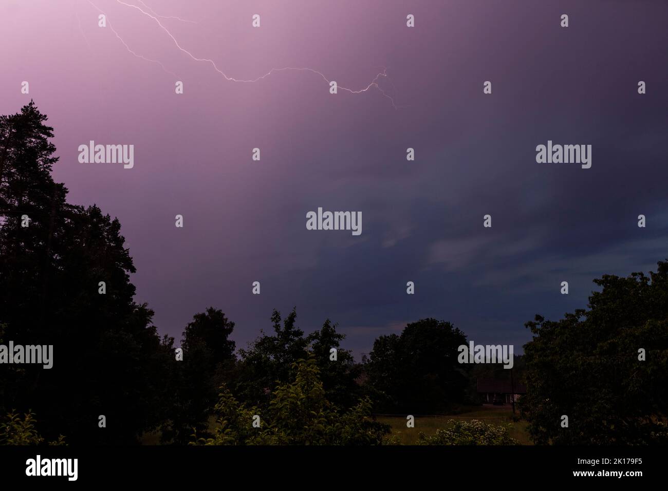 Lightning above trees Stock Photo - Alamy