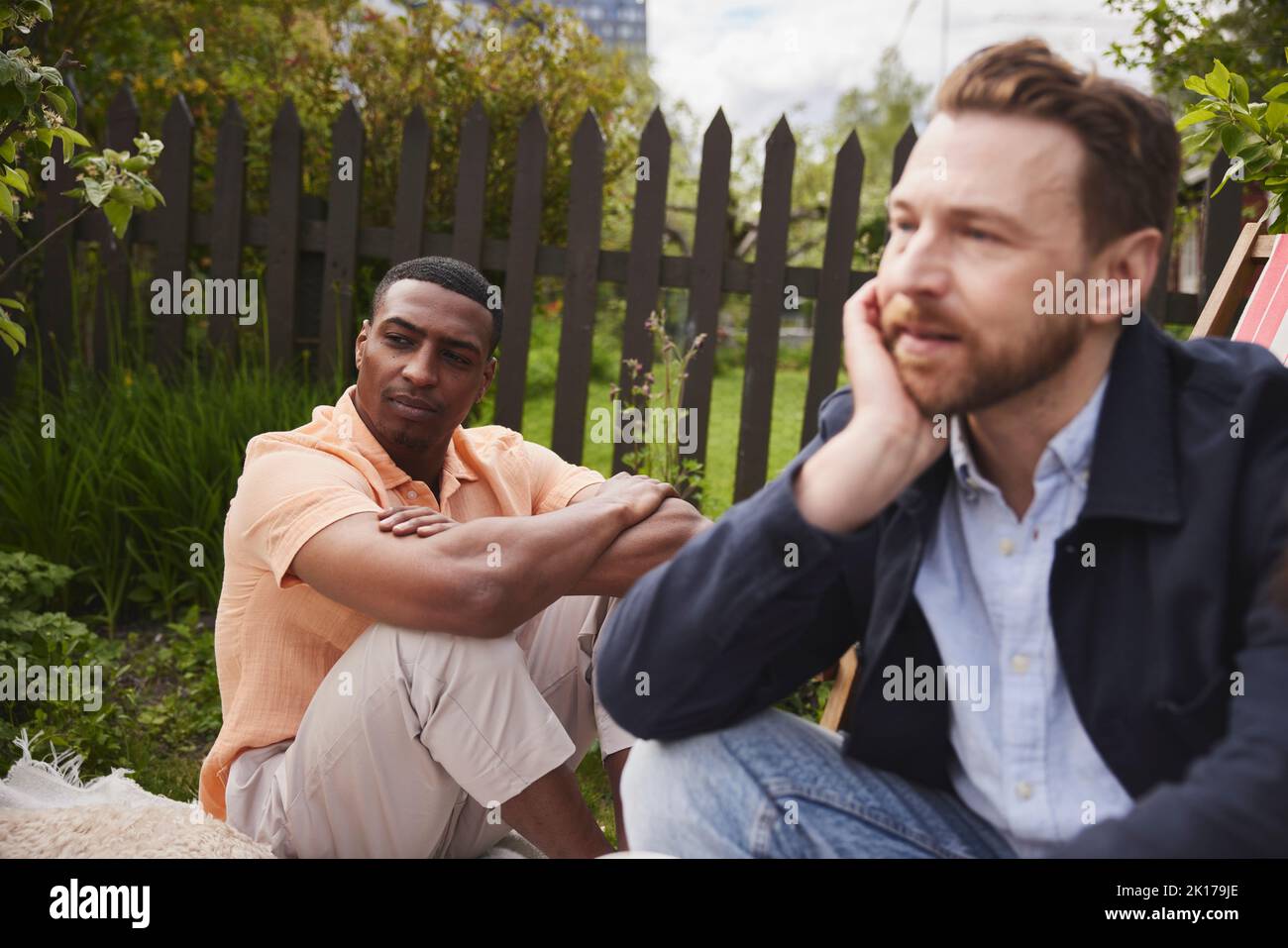 Men sitting in garden Stock Photo - Alamy