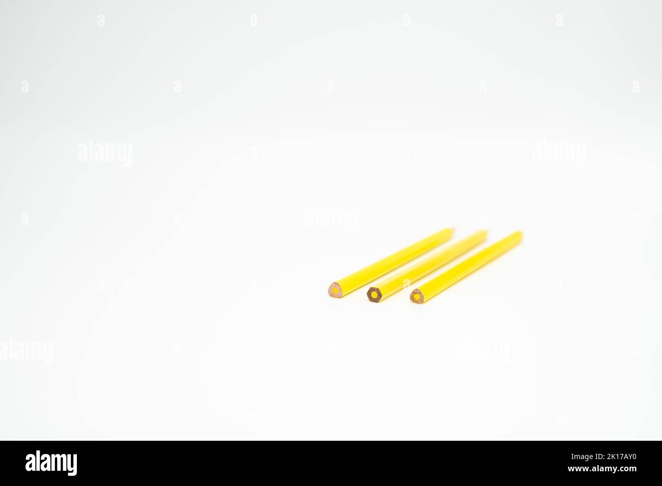 Yellow wooden colored pencil on a white background with end part in ...