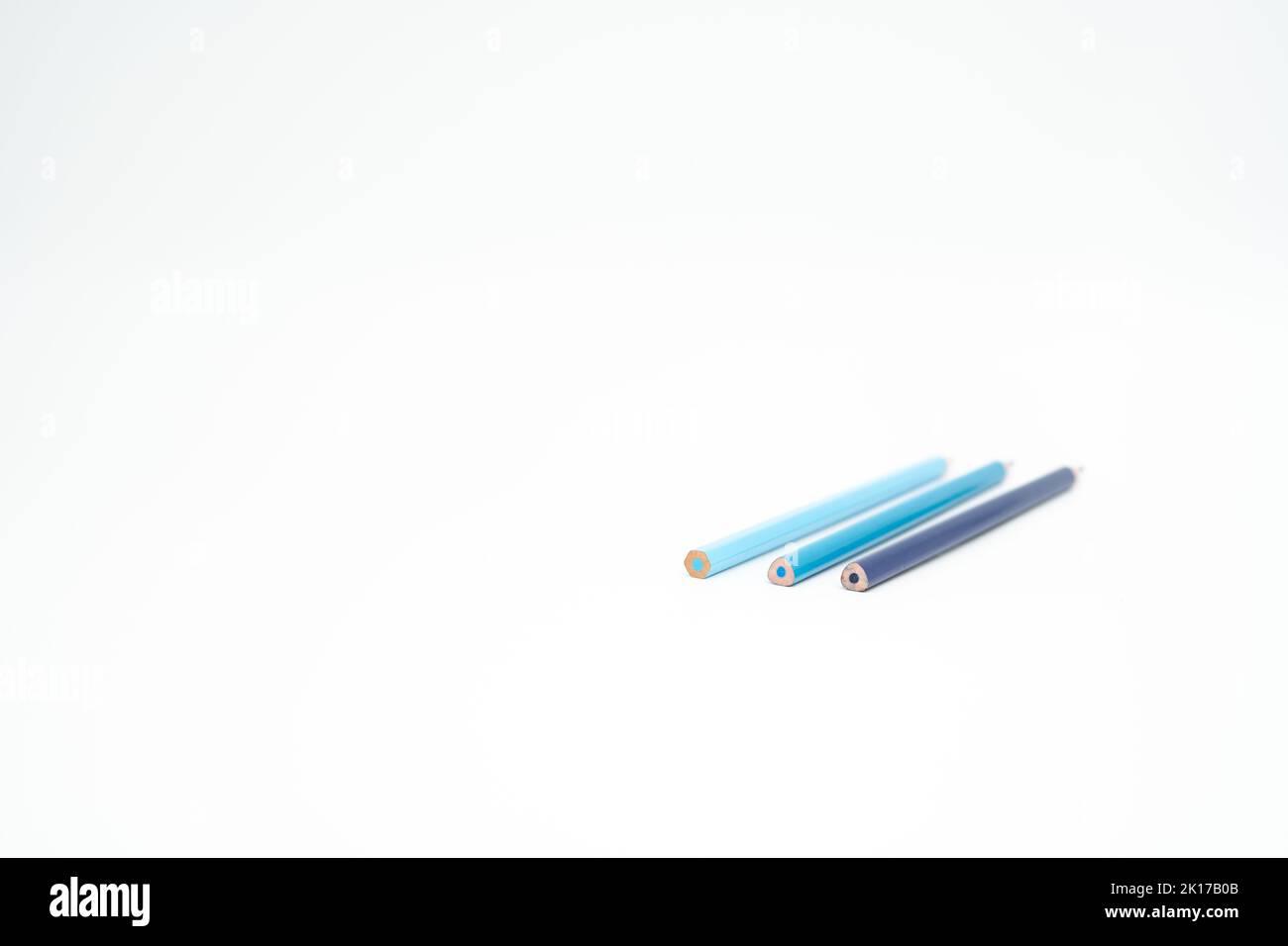 blue wooden colored pencils on a white background with end part in ...