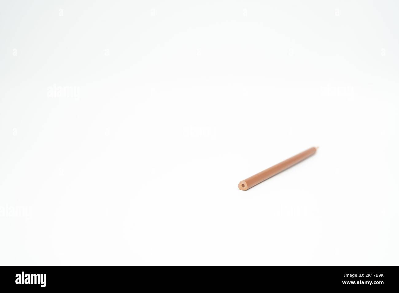 Brown wooden colored pencil on a white background with end part in ...