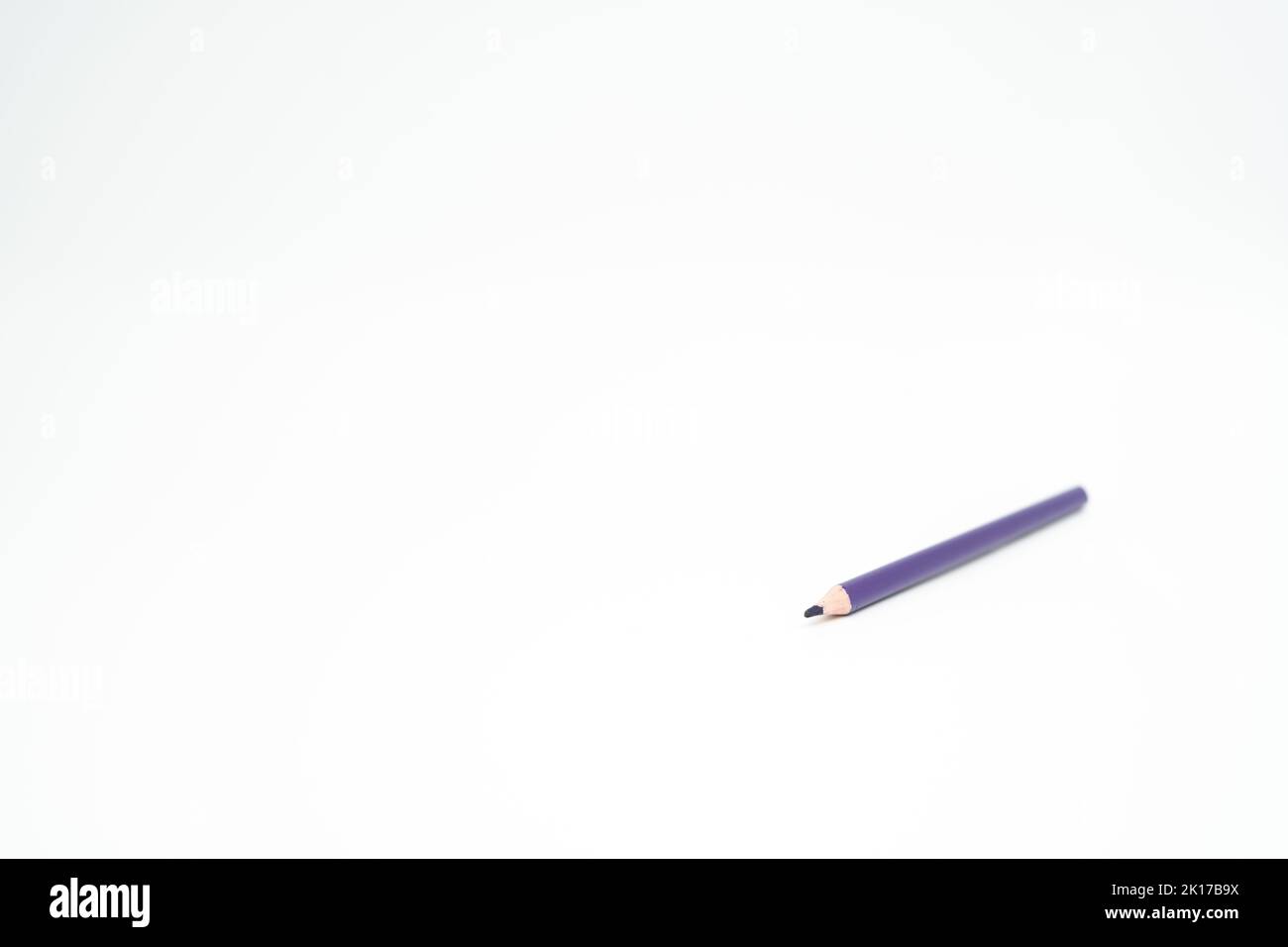 Purple wooden colored pencil on a white background with a point (lead ...