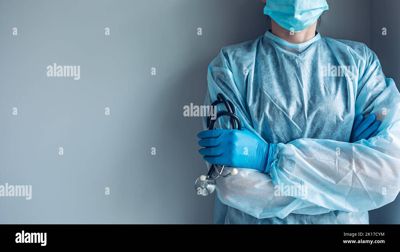 Medical worker portrait without face dressed in disposable medical gown ...