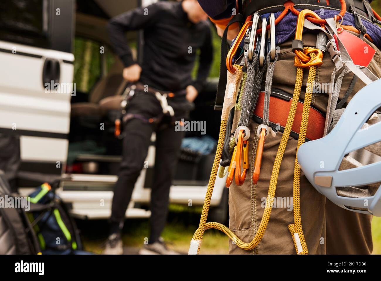Rock climbers putting gear on Stock Photo - Alamy