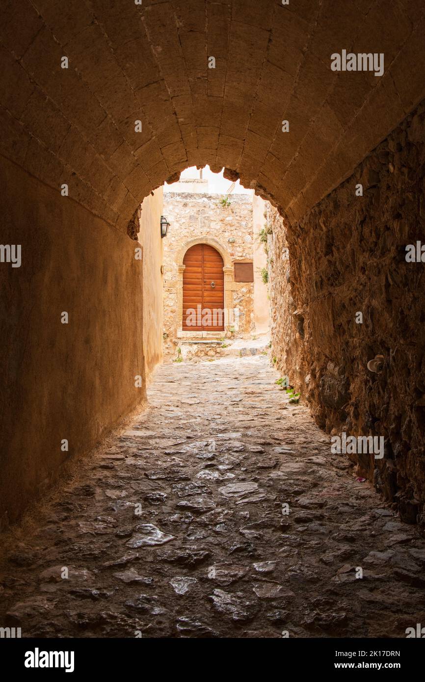 A vertical shot of a tunnel passage leading to an old house door Stock ...