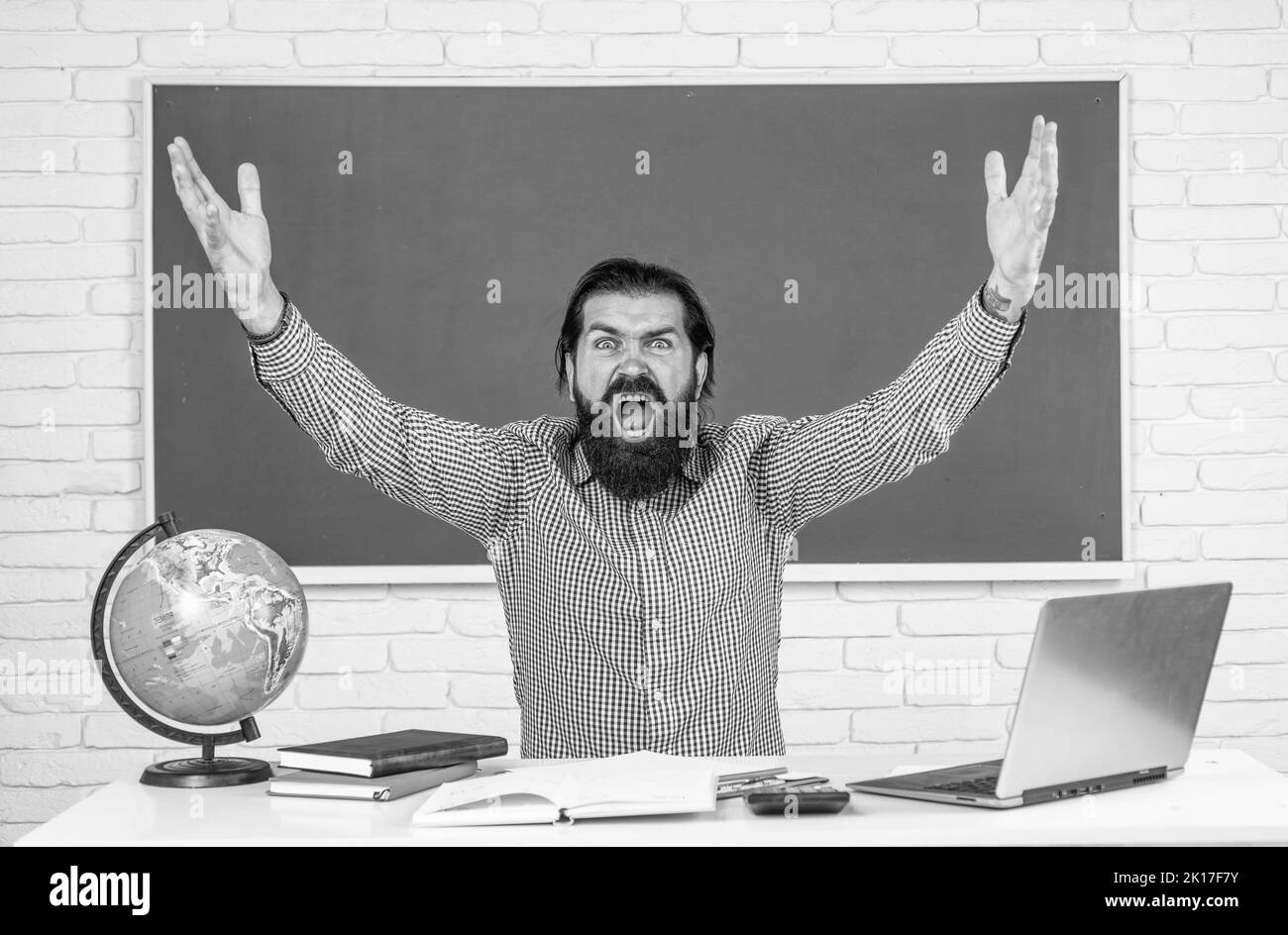 mature bearded man teacher in costume sit in school classroom with ...