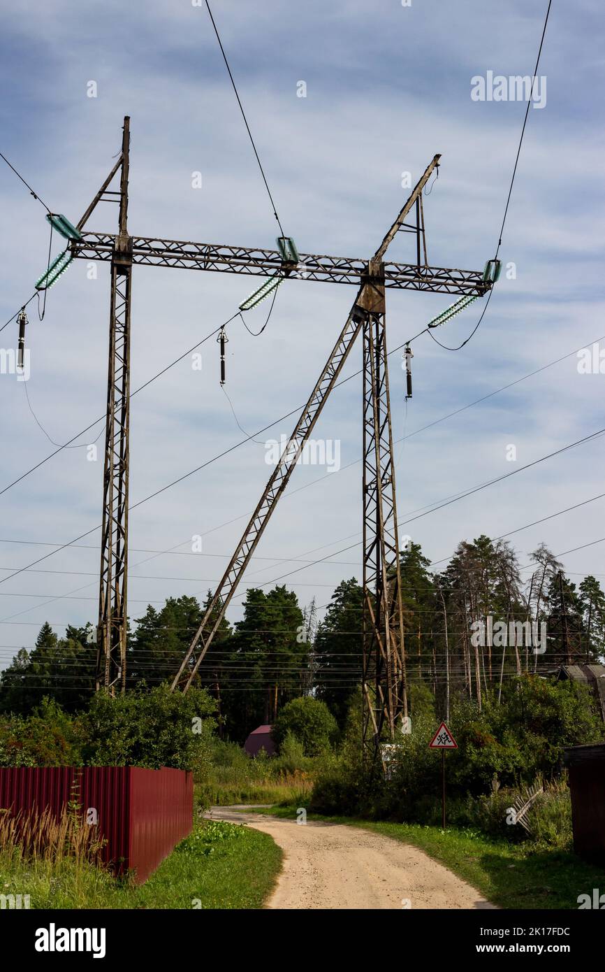 High-voltage power line passing over summer cottages Stock Photo - Alamy