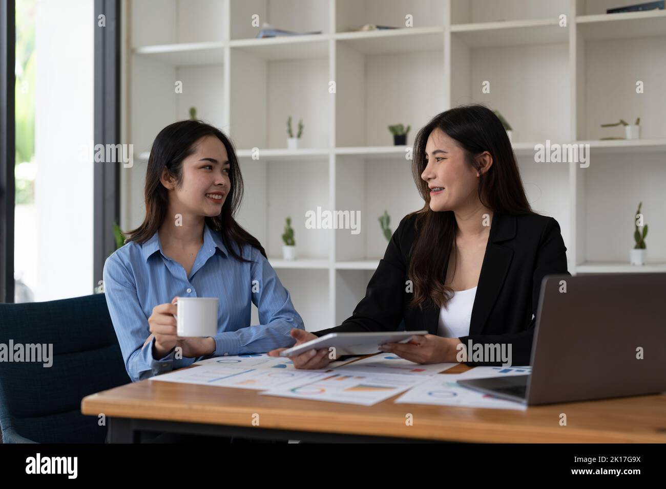 Two asian business woman workers smiling happy and confident. Working ...