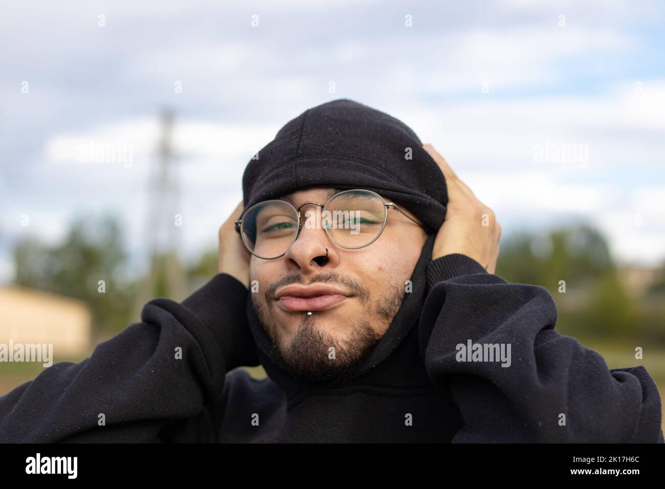 Portrait man covering ears hi-res stock photography and images - Alamy