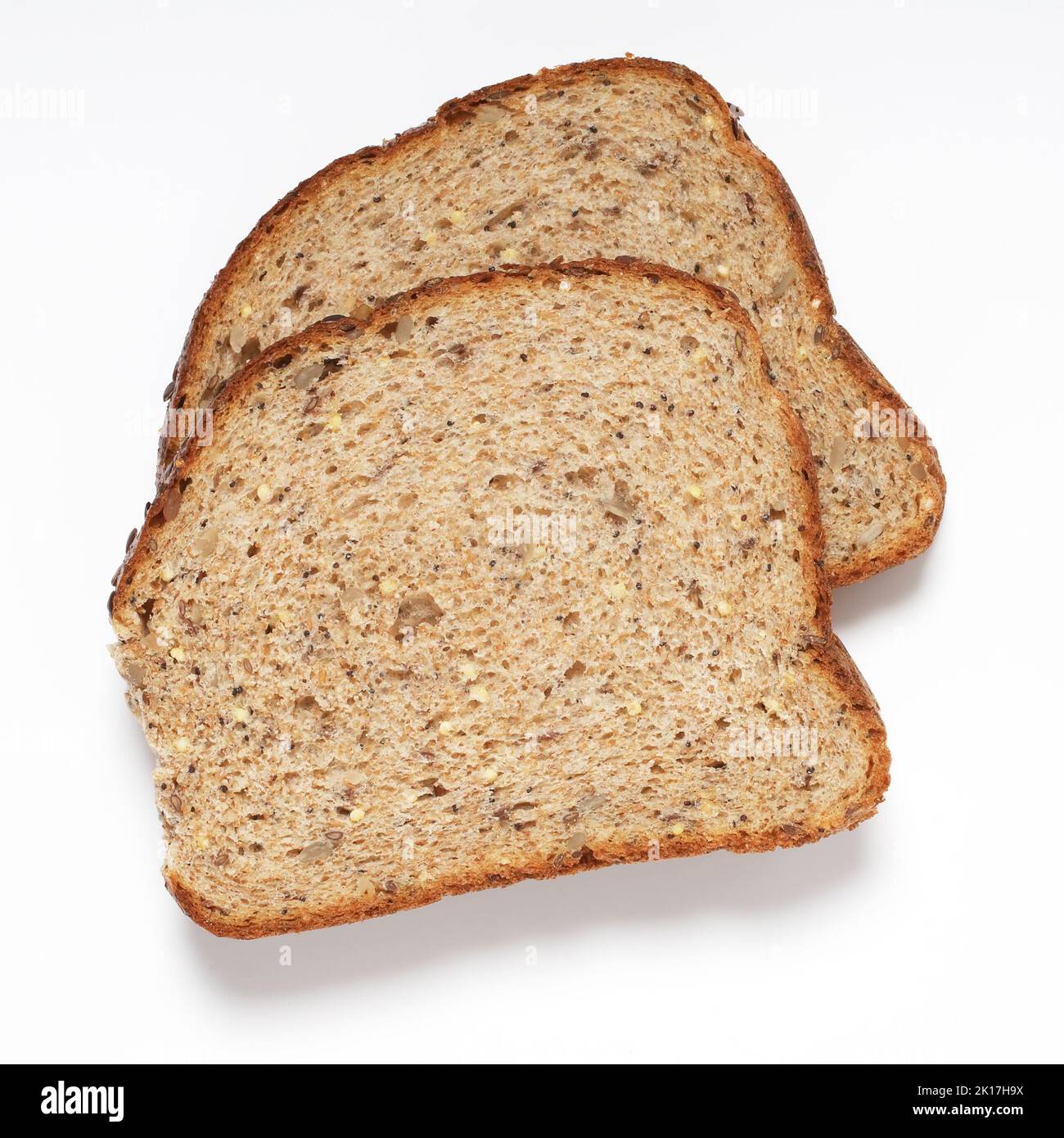 Slices of wholemeal multiseed bread on white background cut out Stock ...