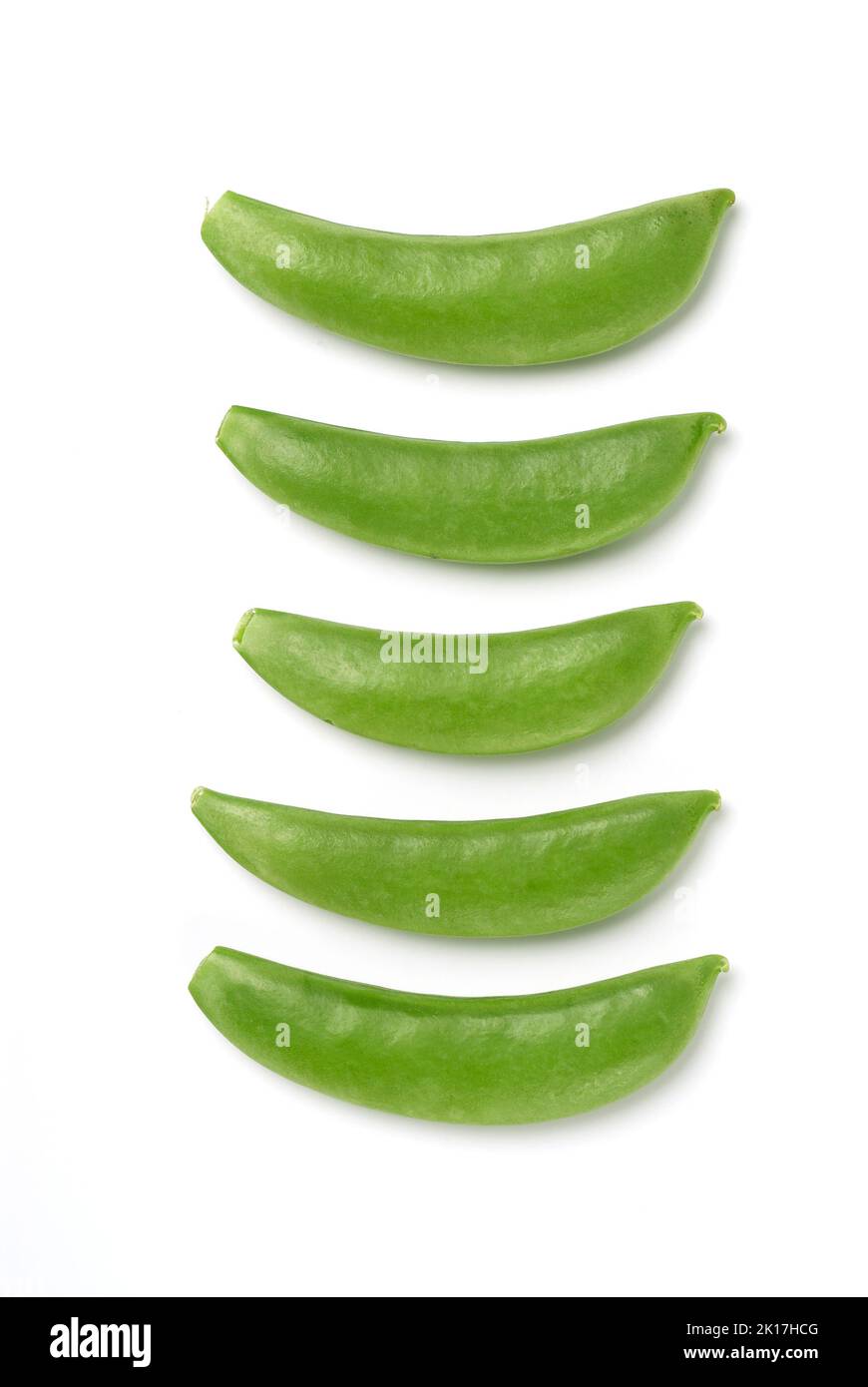Vertical row of sugar snap peas on white cut out Stock Photo - Alamy
