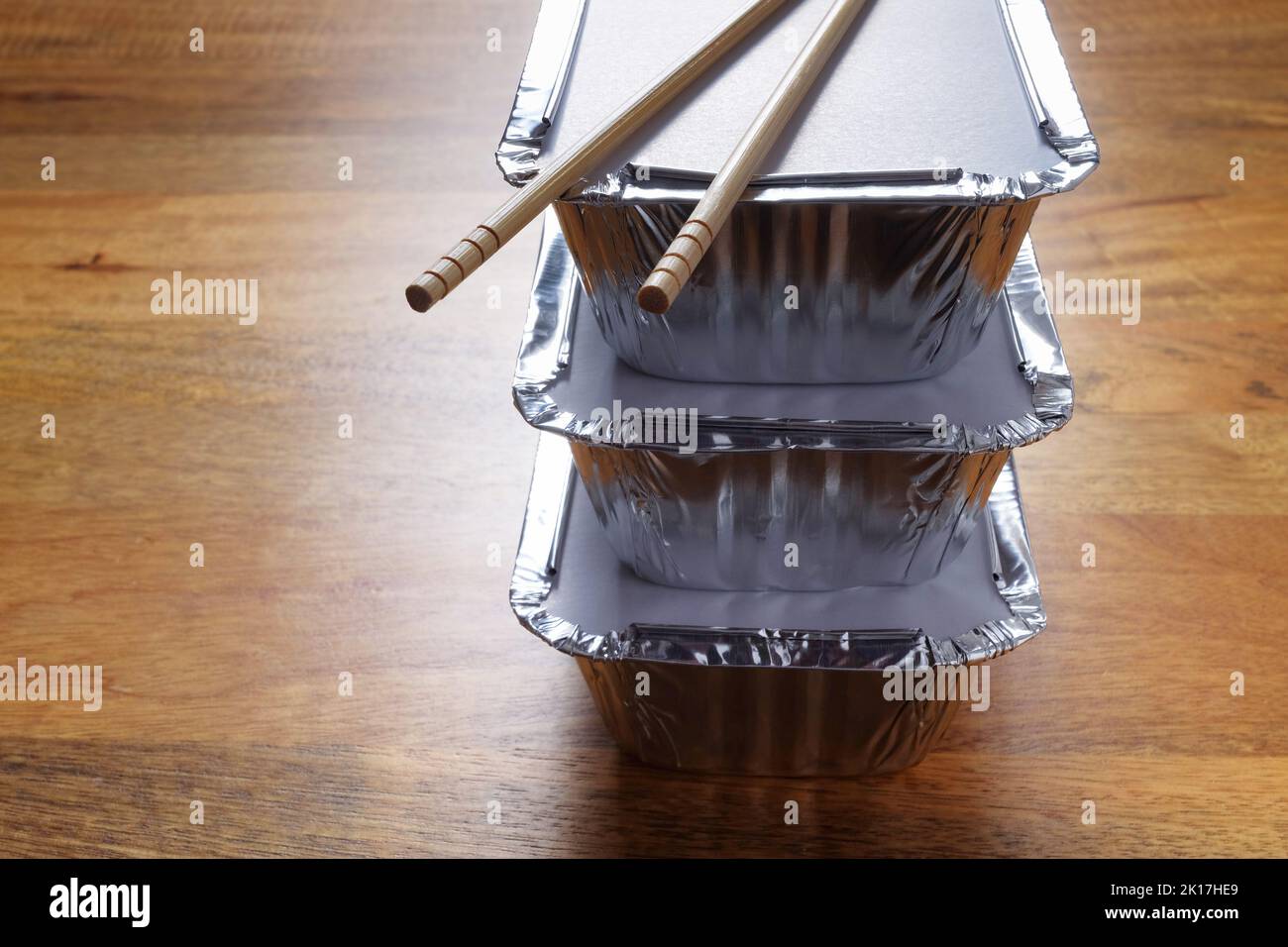 Stack of silver foil takeaway trays with chopsticks placed on top Stock ...
