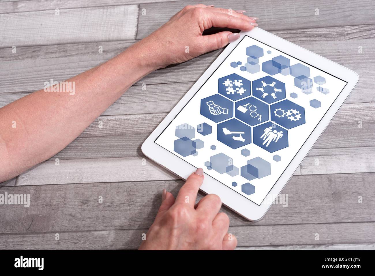 Teamwork concept shown on a tablet used by a woman Stock Photo - Alamy