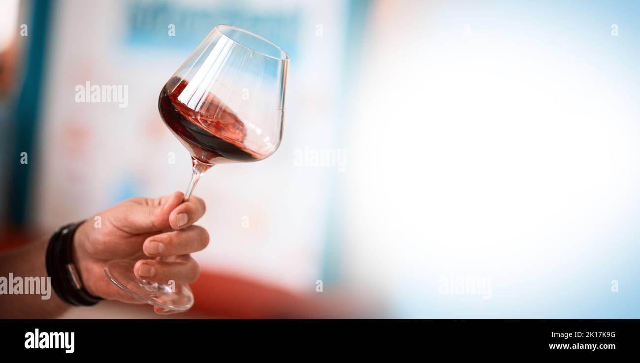 Glass of red wine in hand on tasting of alcoholic beverages image for ...
