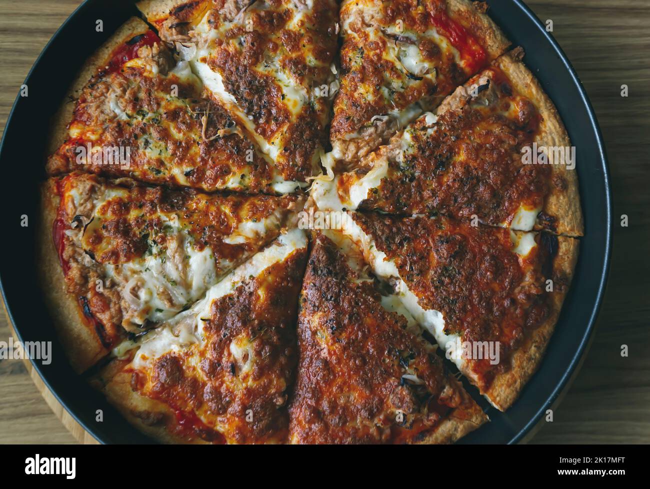 Tasty tuna pizza with anchovies and green pepper. Delicious traditional ...