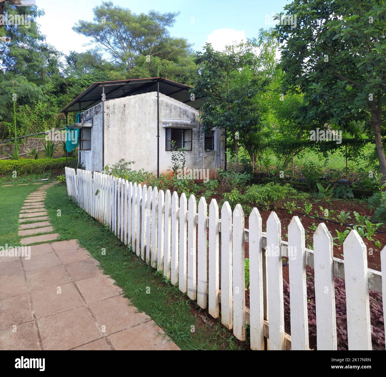 Wooden fence on private property separted from walking path in Pune ...