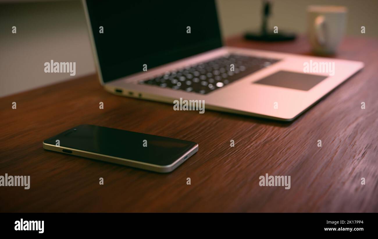 focus on laptop with laptop in background Stock Photo - Alamy