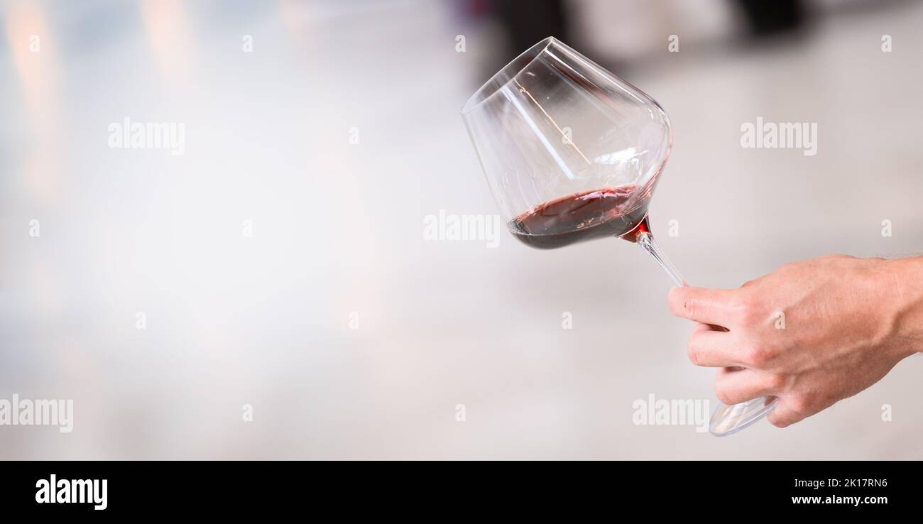 Glass of red wine in hand on tasting of alcoholic beverages image for ...