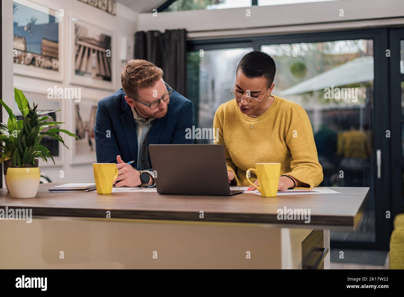 Busy adult businessman, listening to his short haired female partner ...