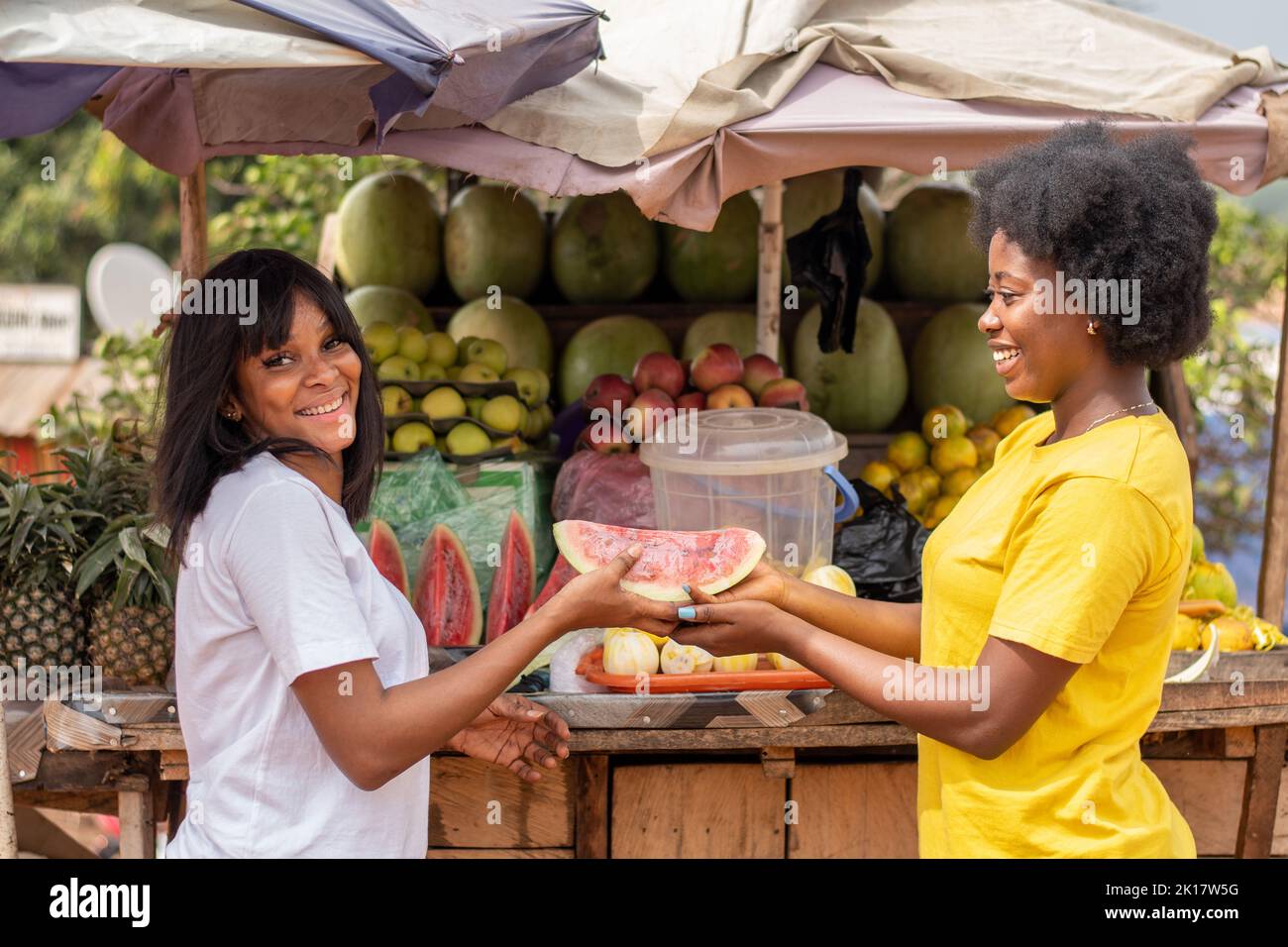 african lady buying fruits from a market woman Stock Photo - Alamy