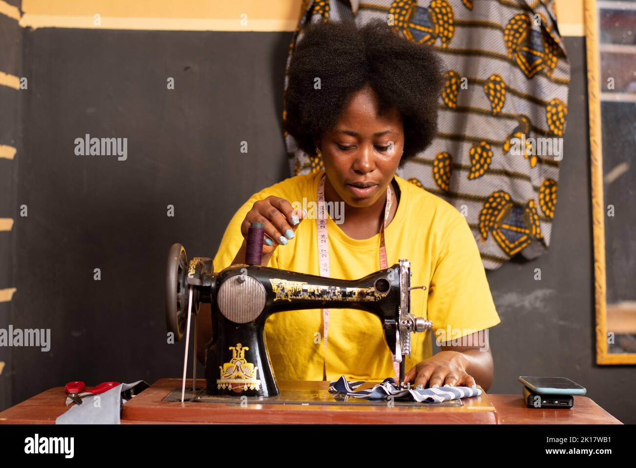 female african tailor sewing with her machine Stock Photo - Alamy