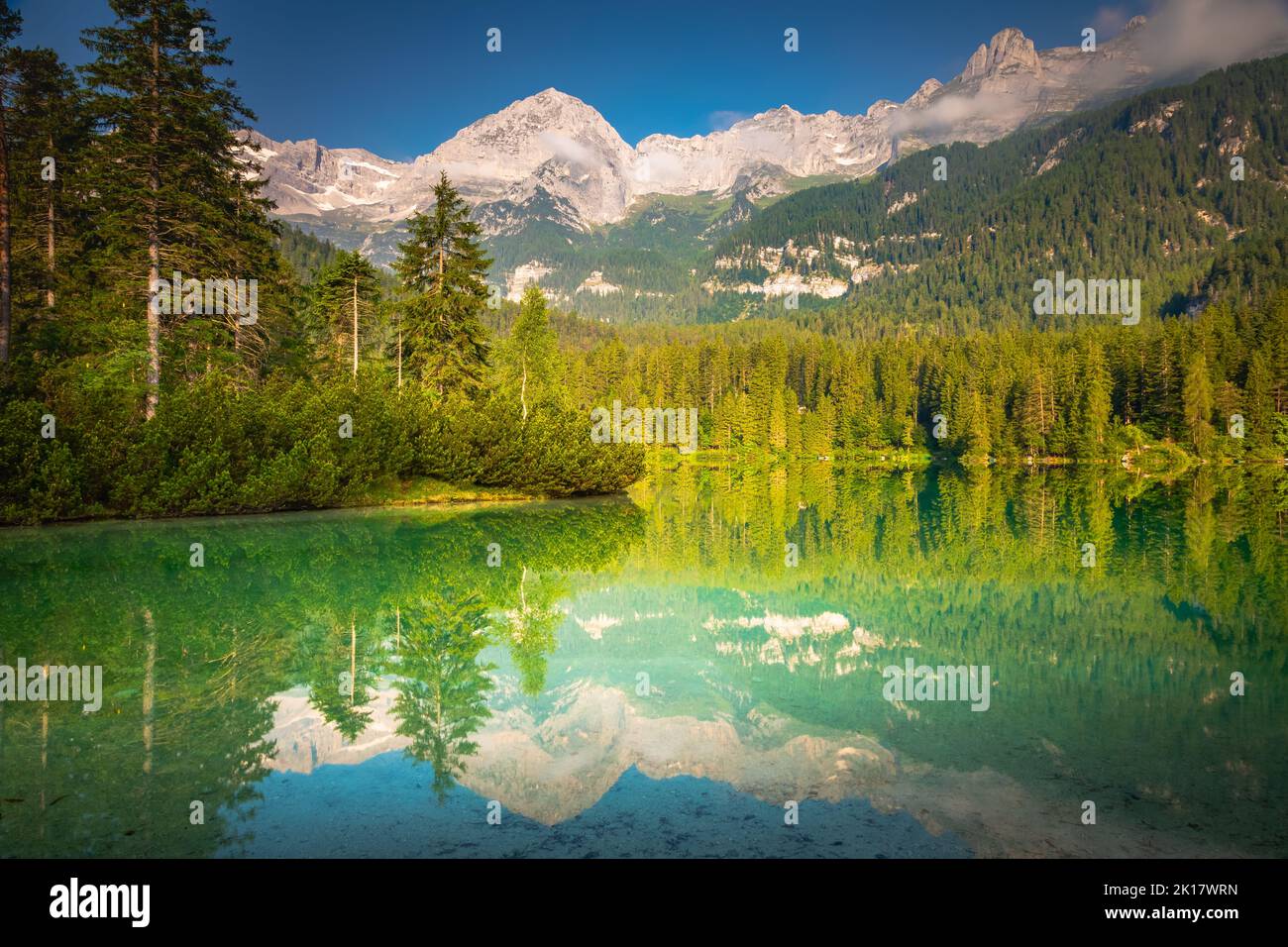 Lake Tovel reflection symmetry in Trentino-Alto Adige, Dolomites, Italy ...