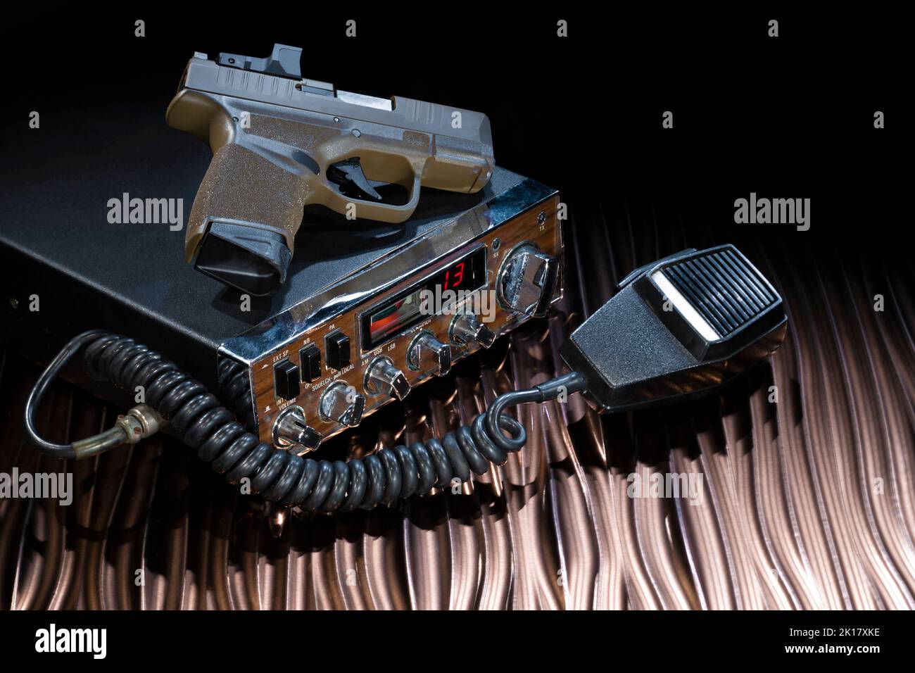 Two way radio and handgun on a copper colored table Stock Photo - Alamy