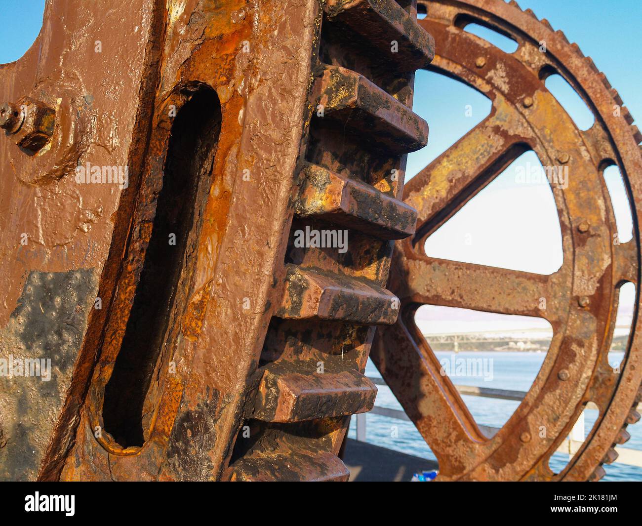 Historic dredge wheel close-up with rusty surface and the gear and ...