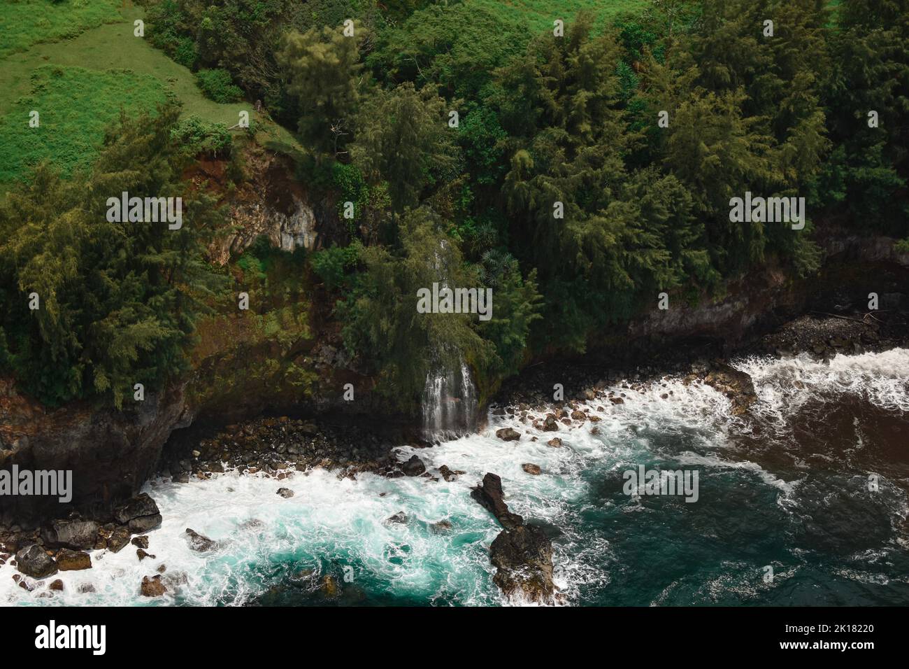 A bird's-eye view of a waterfall coming out from a cliff Stock Photo ...