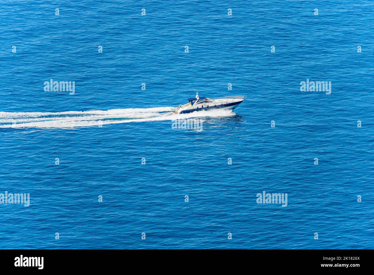 Aerial view of a luxury speedboat or yacht in motion in the blue ...