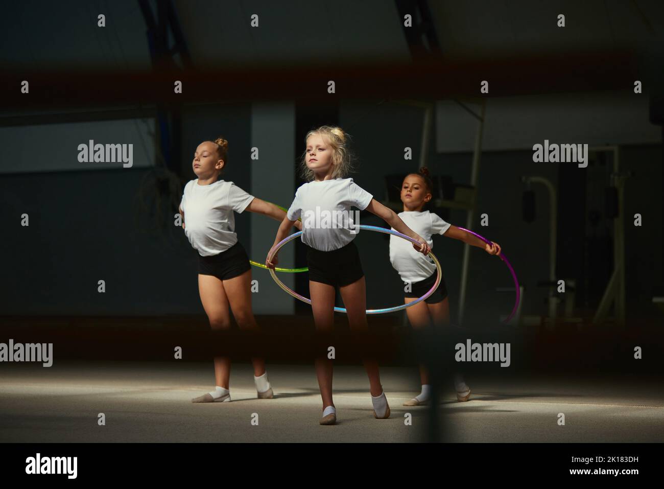 Flexible little girls, female rhythmic gymnasts training with gymnastic ...