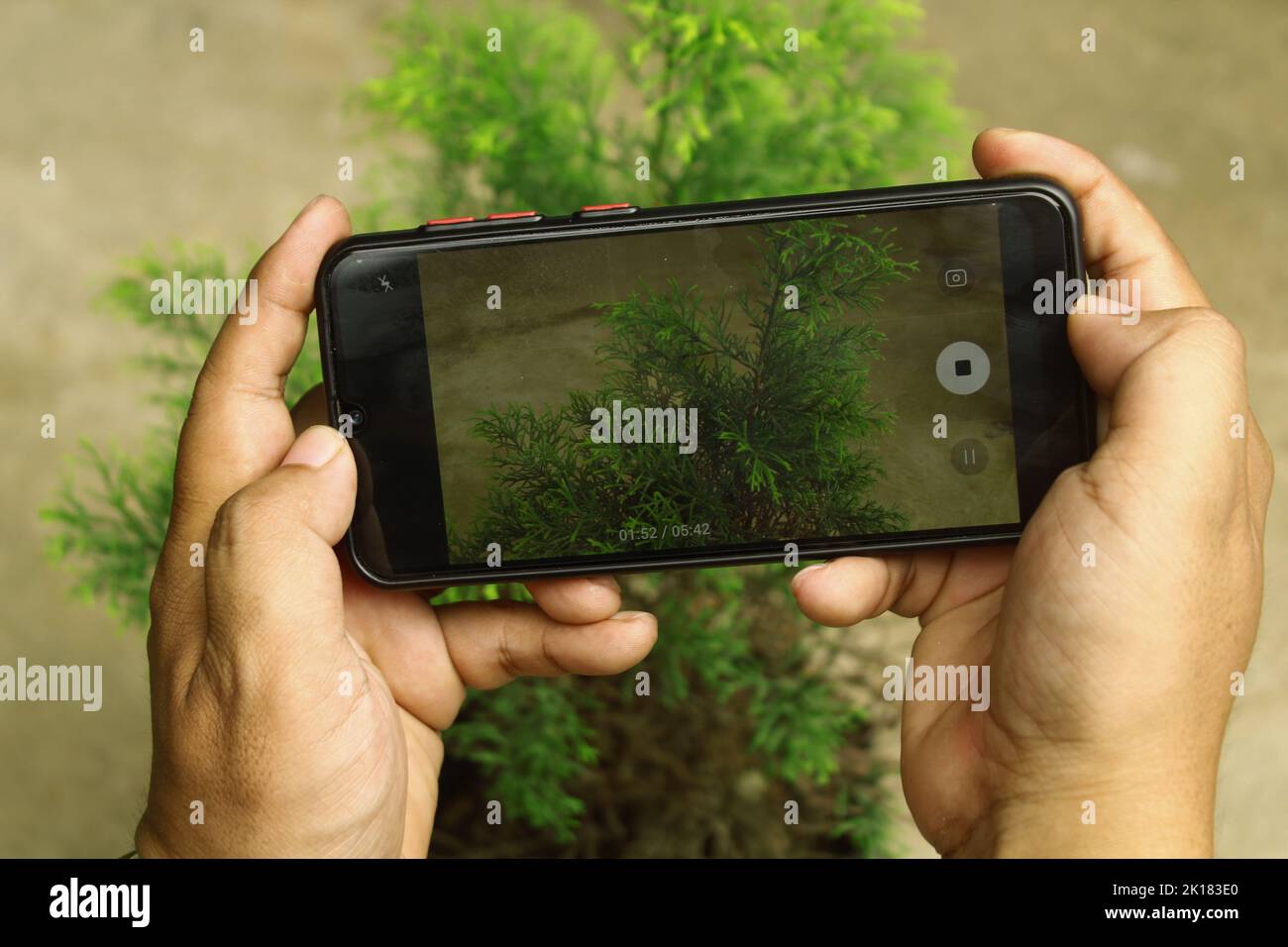 Guy is doing shooting a video , A Mobile phone users is taking video of ...