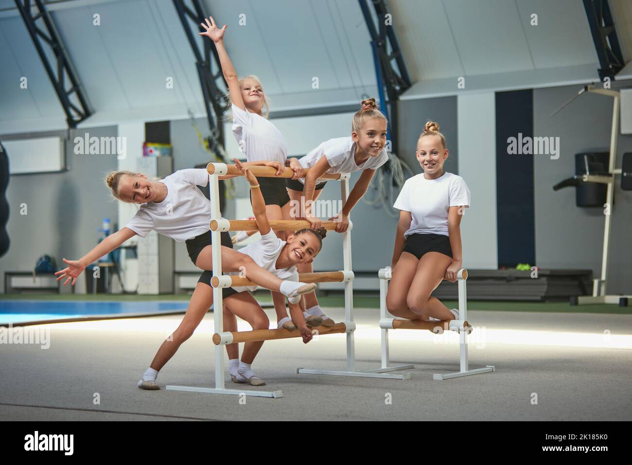 Group of kids, little girls, beginner gymnastics athletes in sports ...