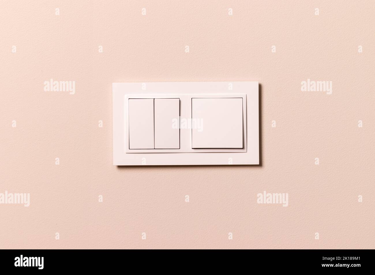 Group of white electrical switches on modern beige wall Stock Photo - Alamy