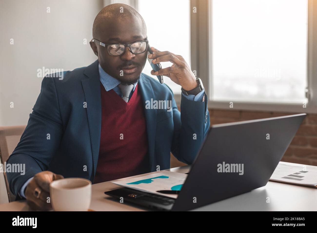 A black African American businessman in a business suit works at a ...