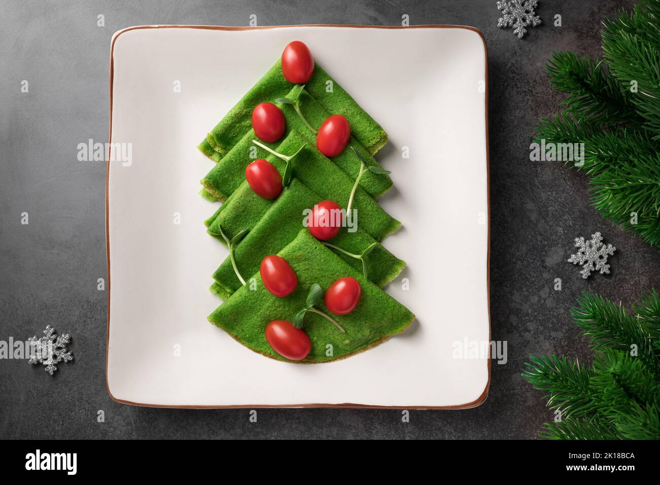 Christmas tree of vegan spinach crepes on ceramic plate Stock Photo - Alamy