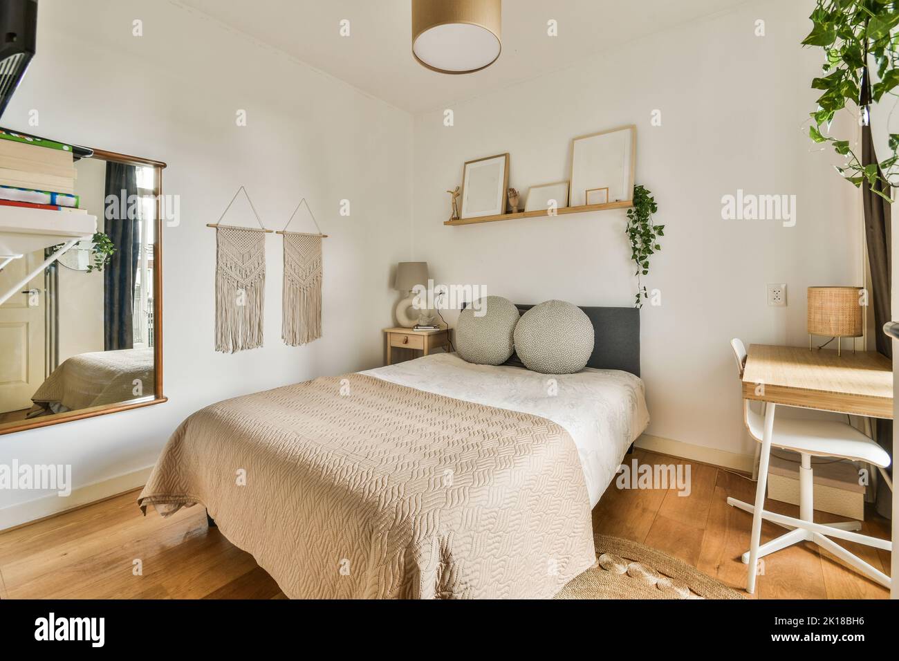 Interior of light bedroom with queen size bed and classic desktop ...