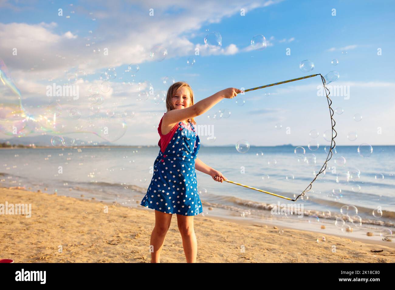 Children blowing bubbles island hi-res stock photography and images - Alamy