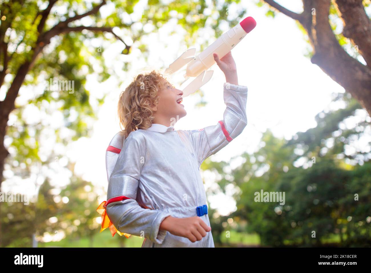 Little boy playing with spaceship. Astronaut costume for Halloween ...