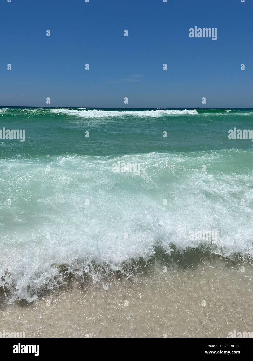 A vertical shot of a sea waves splashing Stock Photo - Alamy