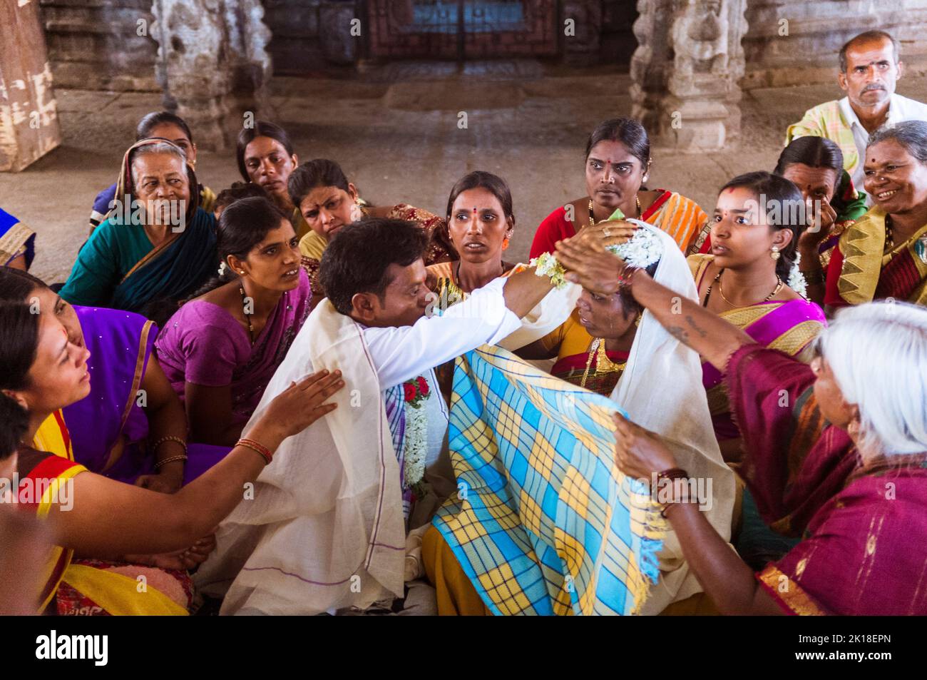 Hampi, Karnataka, India: Bride and groom perform a ritual during a ...
