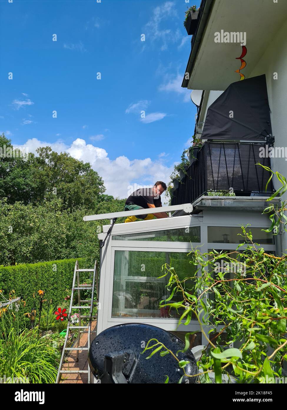 Man cleaning conservatory with a pressure washer - high pressure washer ...