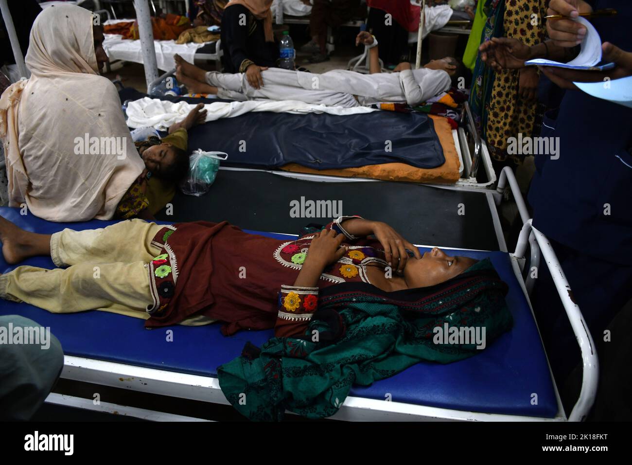 A woman, who became flood victim, takes care of her ailing baby at a ...