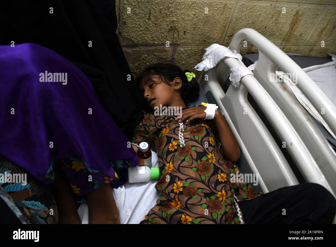 A woman, who became flood victim, takes care of her ailing baby at a ...