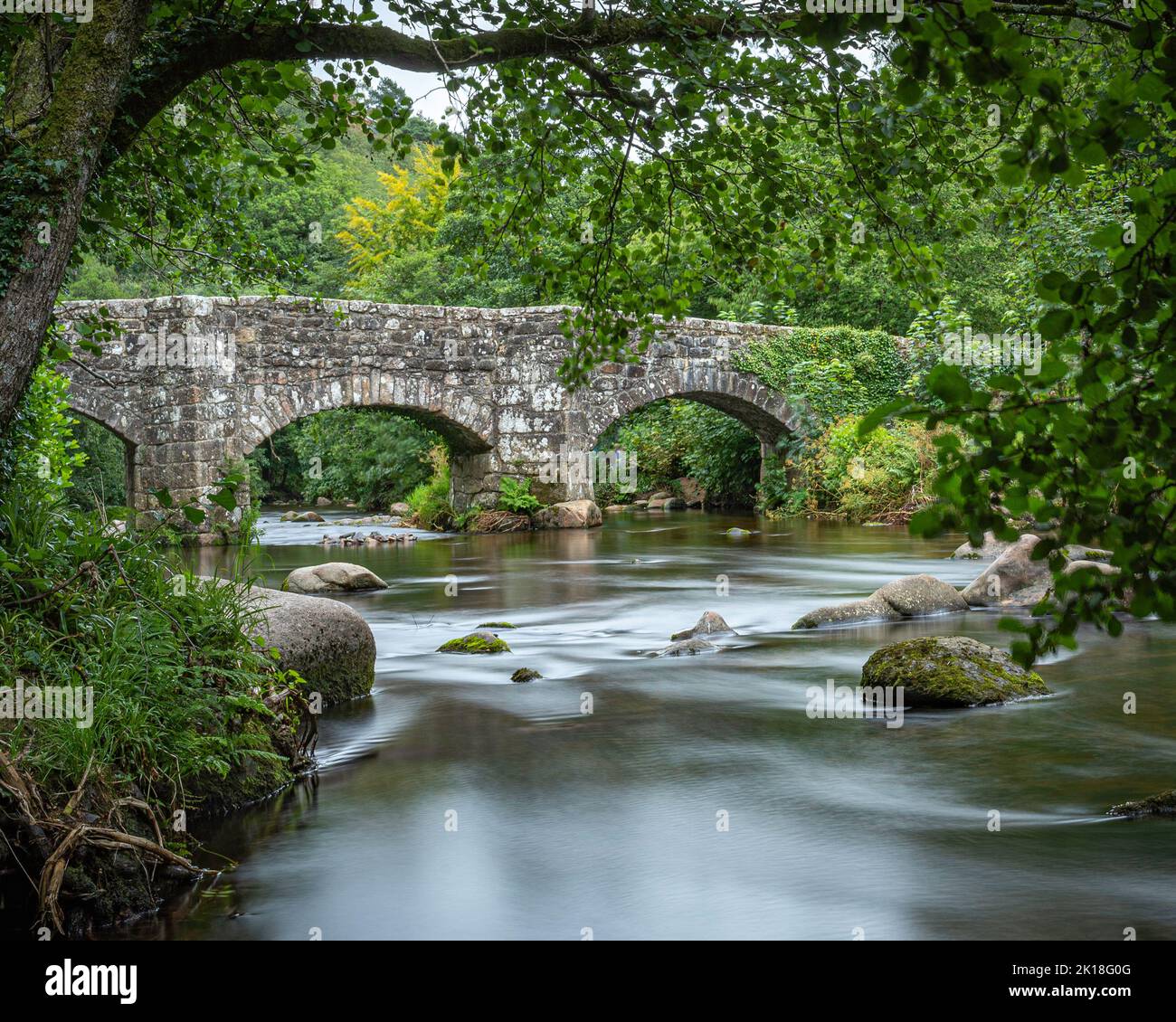 Dartmoor River with stone arch bridge Stock Photo - Alamy
