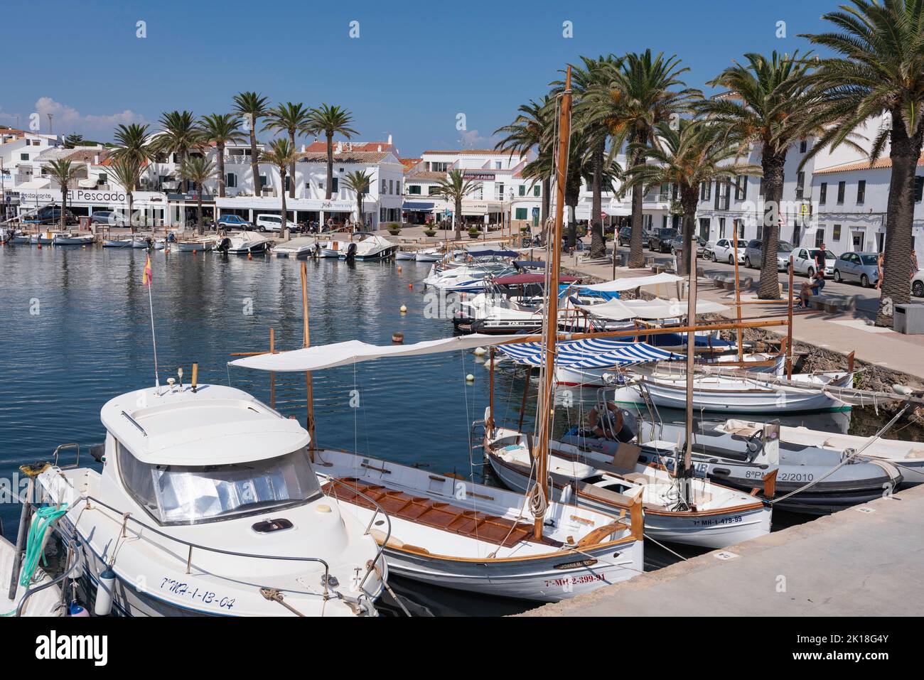 Traditional fishing boats in the harbour of Fornells in Menorca, Spain ...