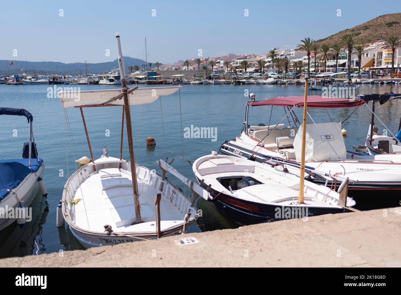 Traditional fishing boats in the harbour of Fornells in Menorca, Spain ...